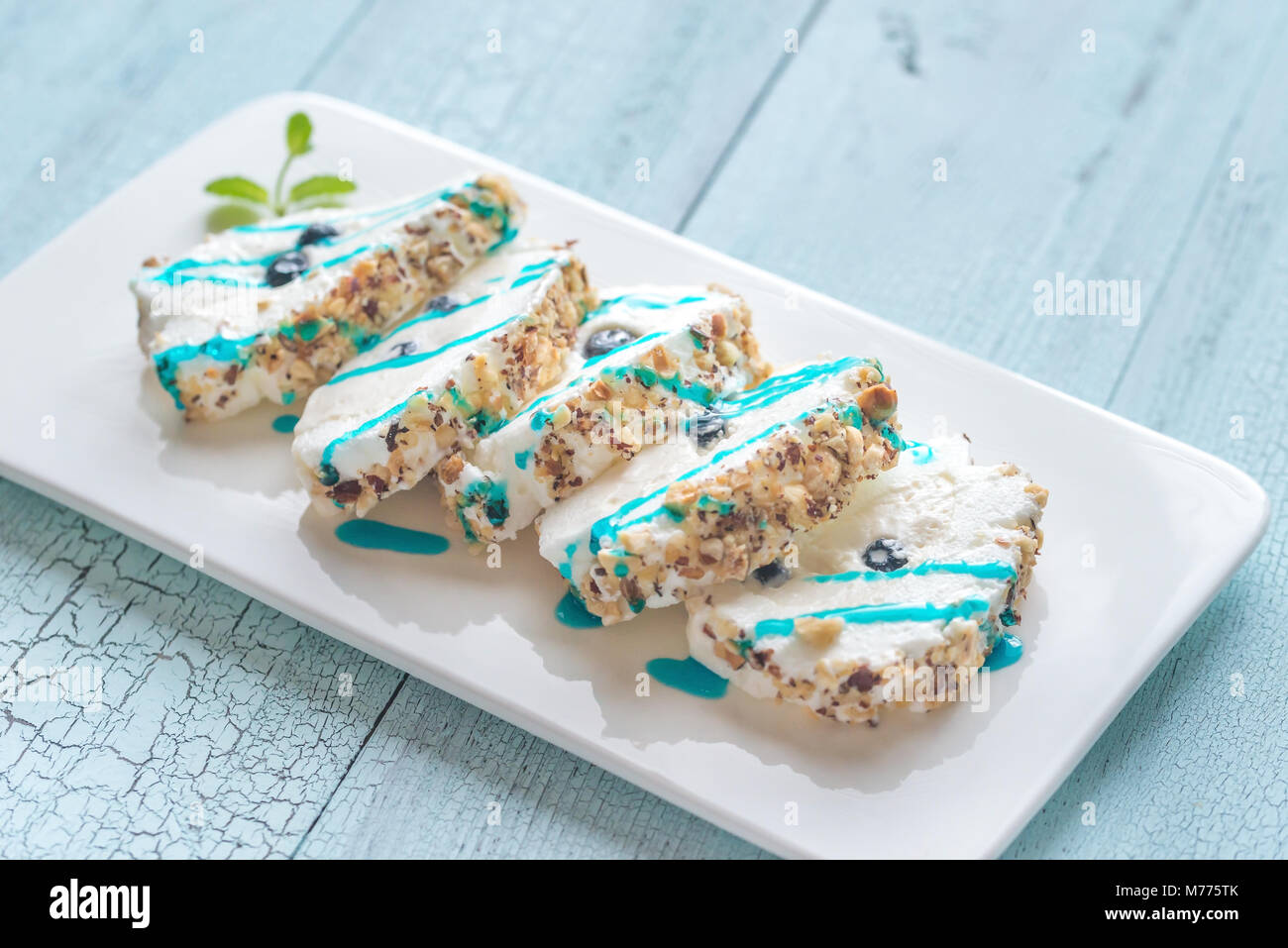 Sliced merengue roll with nuts Stock Photo - Alamy