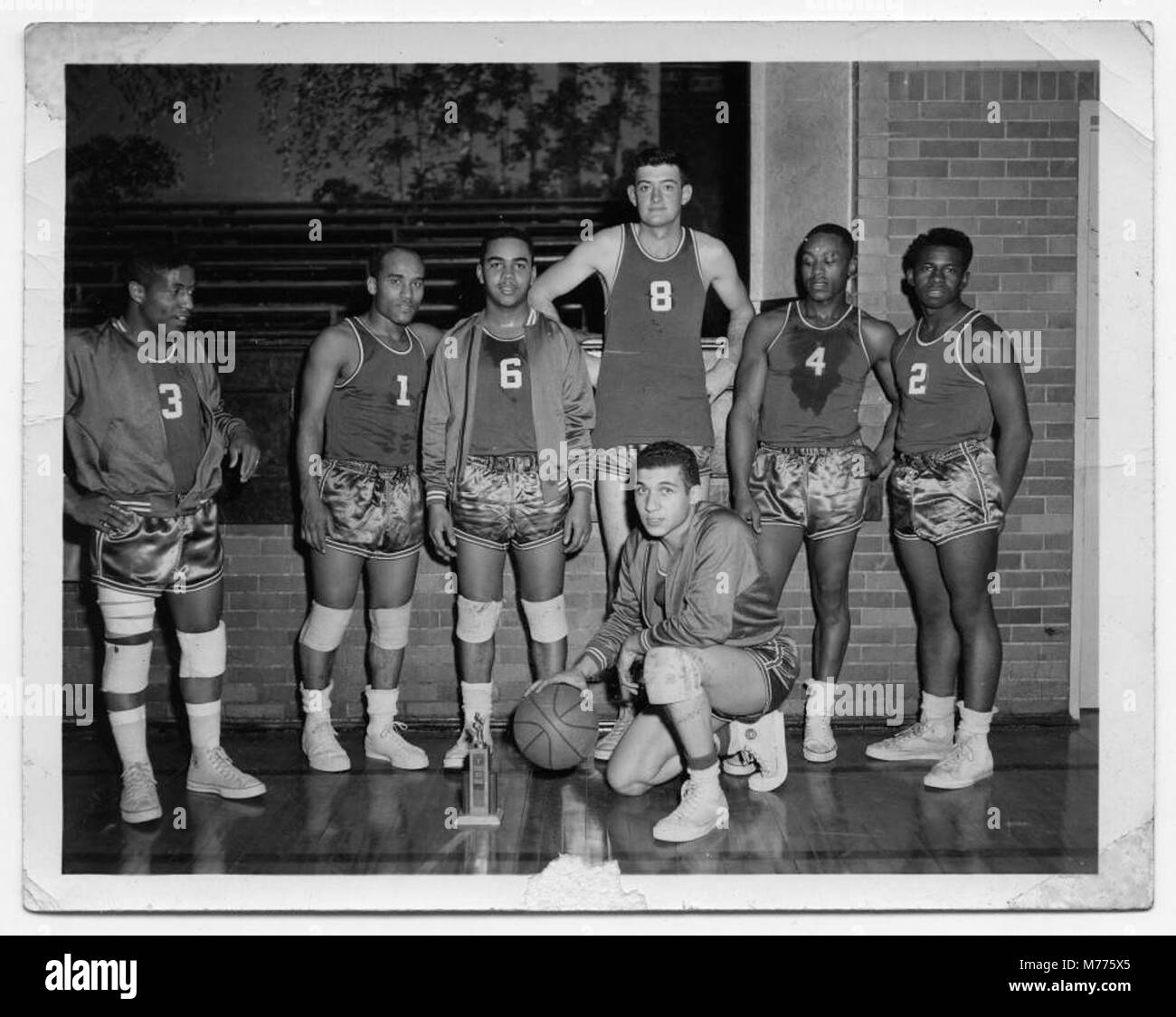A historical photograph of a basketball team, capturing the athletes ...