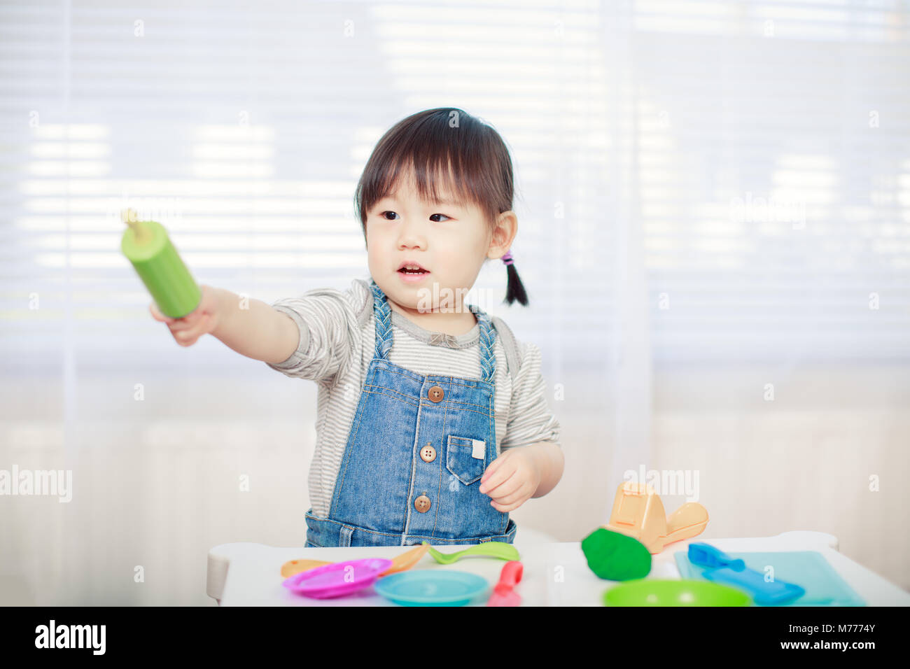 baby girl pretend play food toy Stock Photo - Alamy