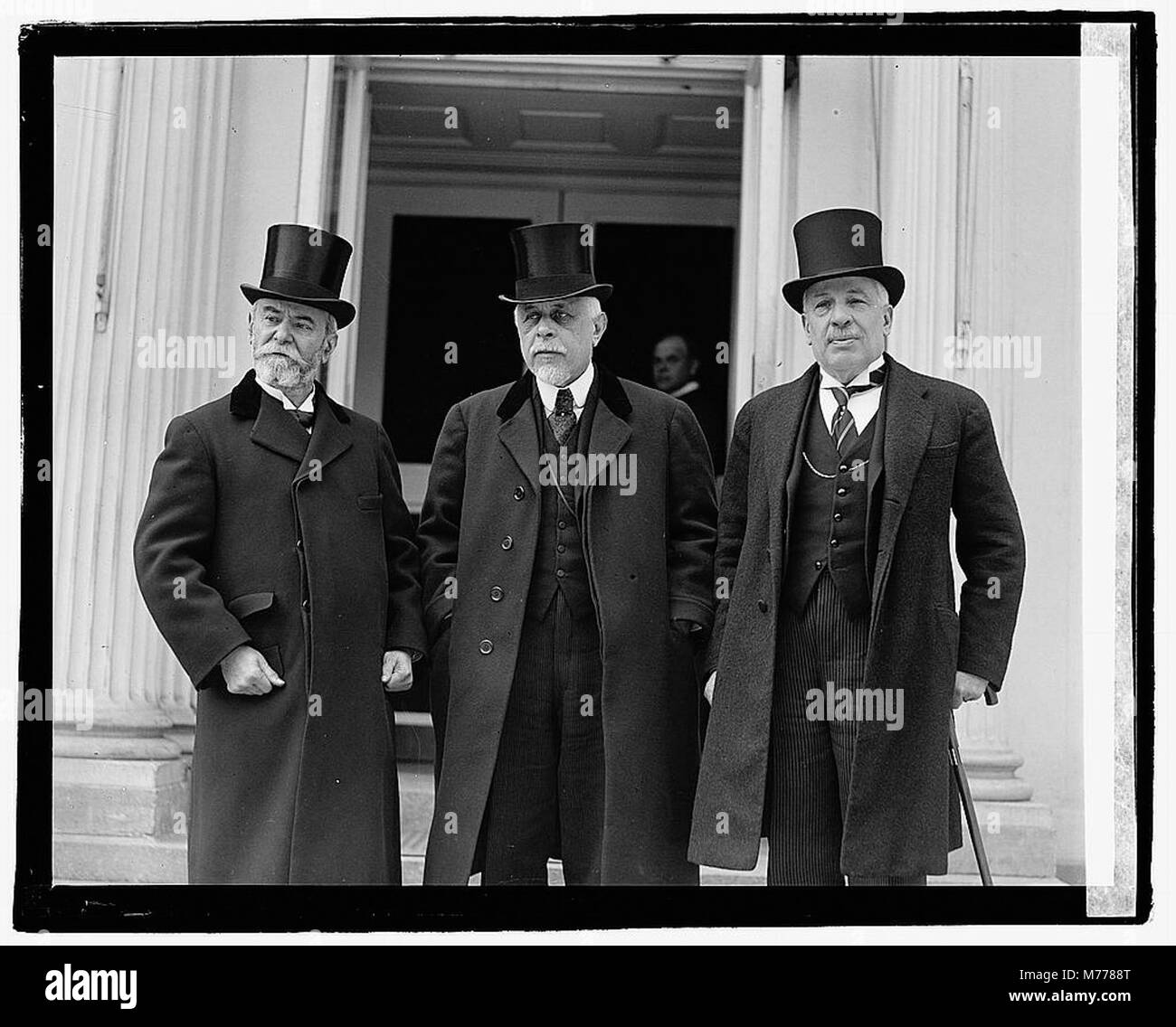 A historical photograph showing three unidentified men standing on the ...