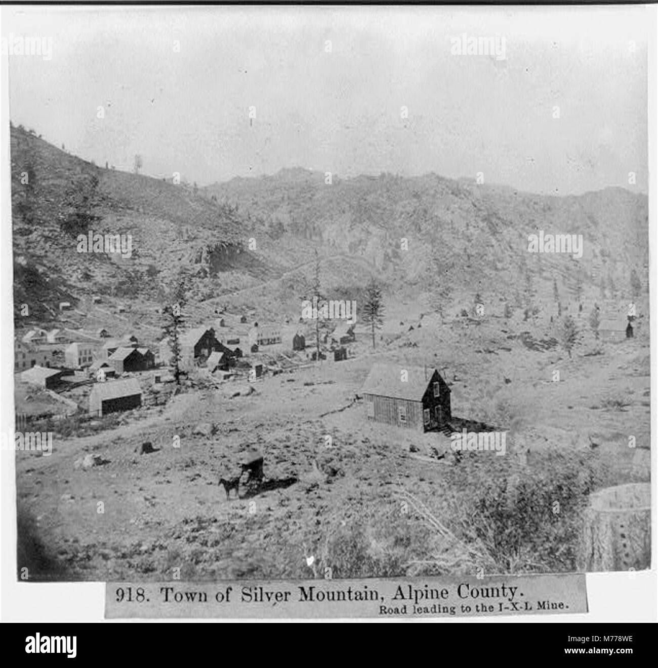 A historic photograph of the road leading to the I-X-L Mine in the town ...
