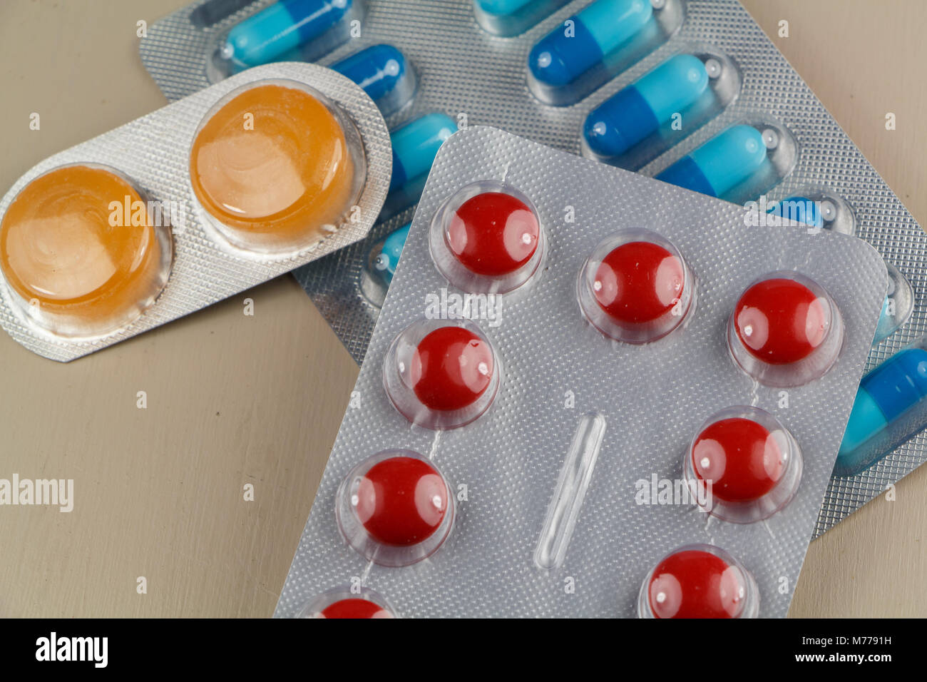 Three packs of red, blue and orange pills Stock Photo - Alamy