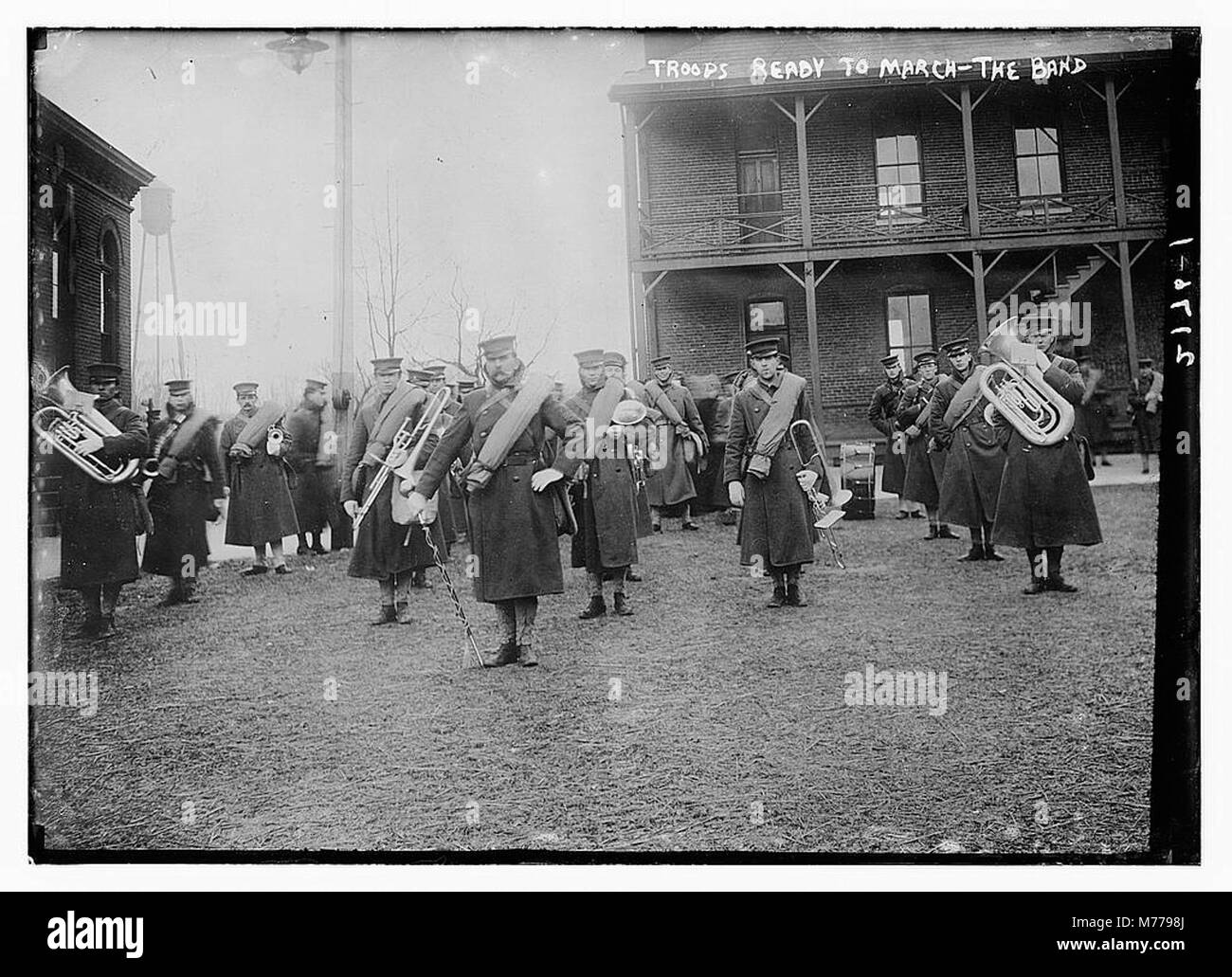 The image depicts troops preparing for a march, accompanied by a band ...