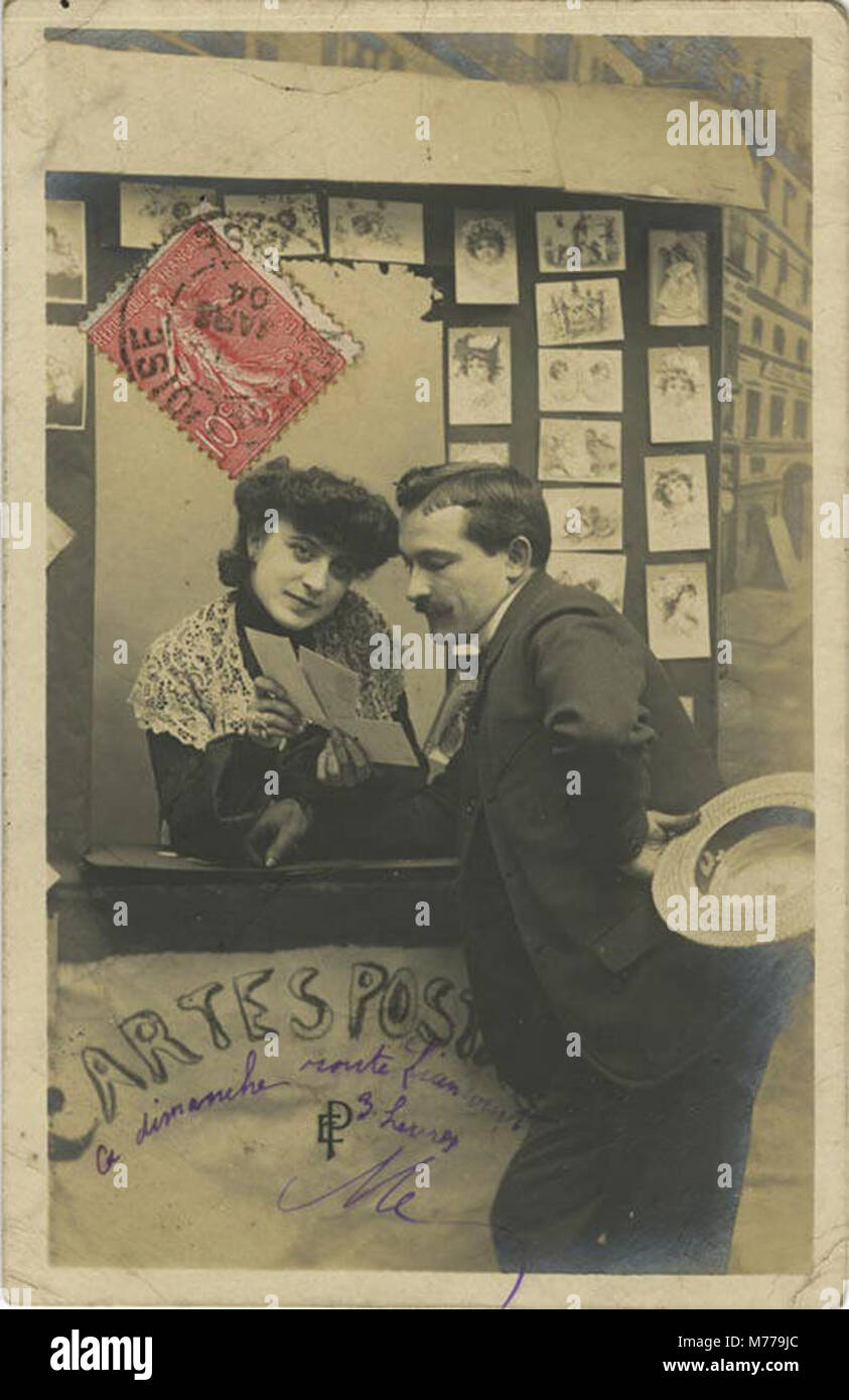 Two individuals posed with postcards, captured in a vintage photograph ...