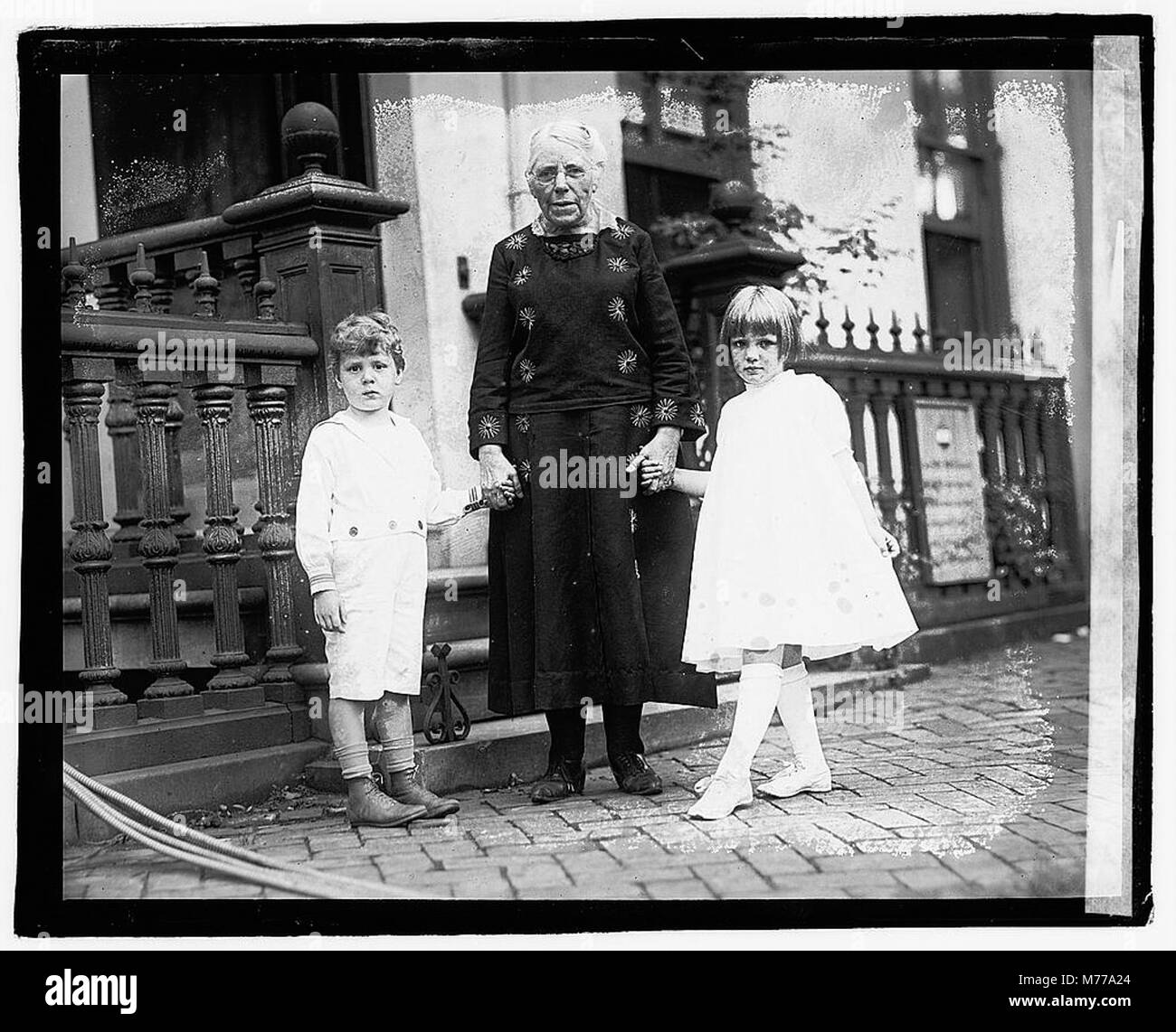 A photograph from May 17, 1922, showing an unidentified woman with two ...