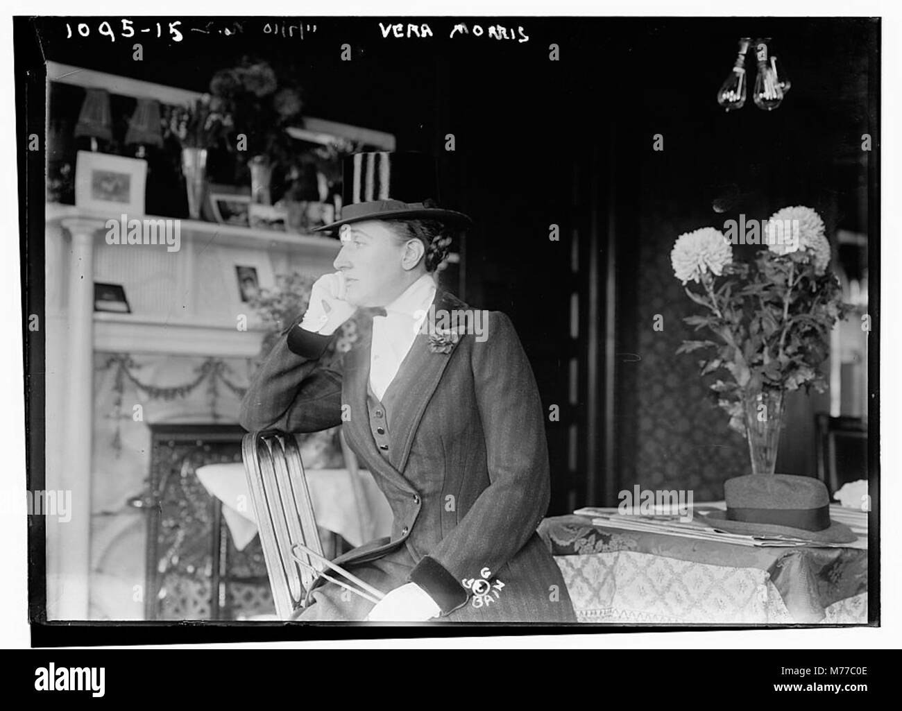 A photograph of Vera Morris seated in a room, dressed in a riding ...