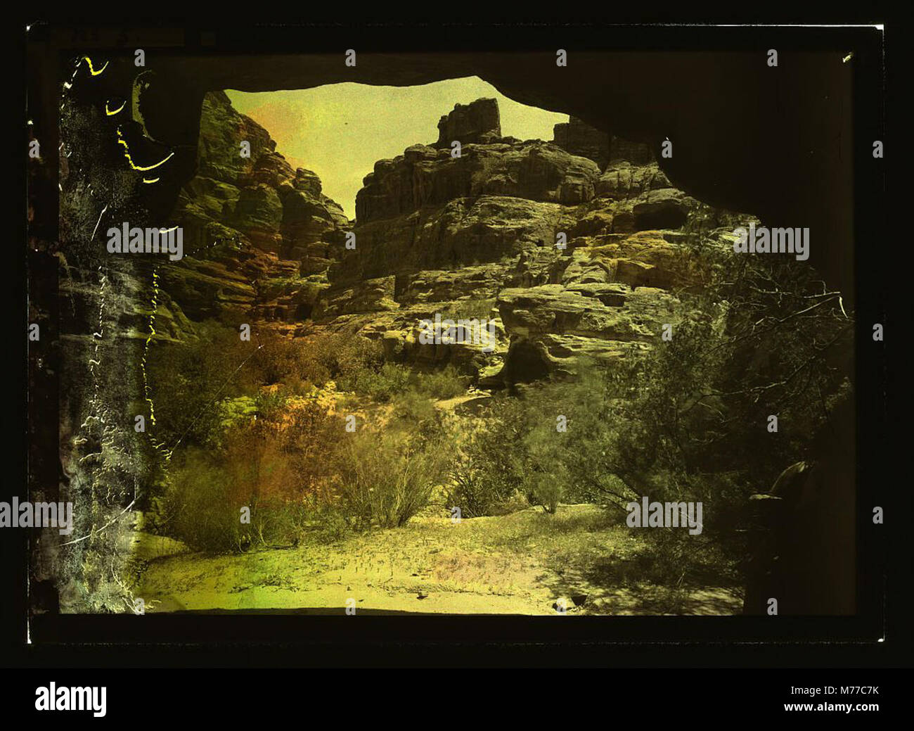 A photograph showing the view from inside a cave, offering a unique ...