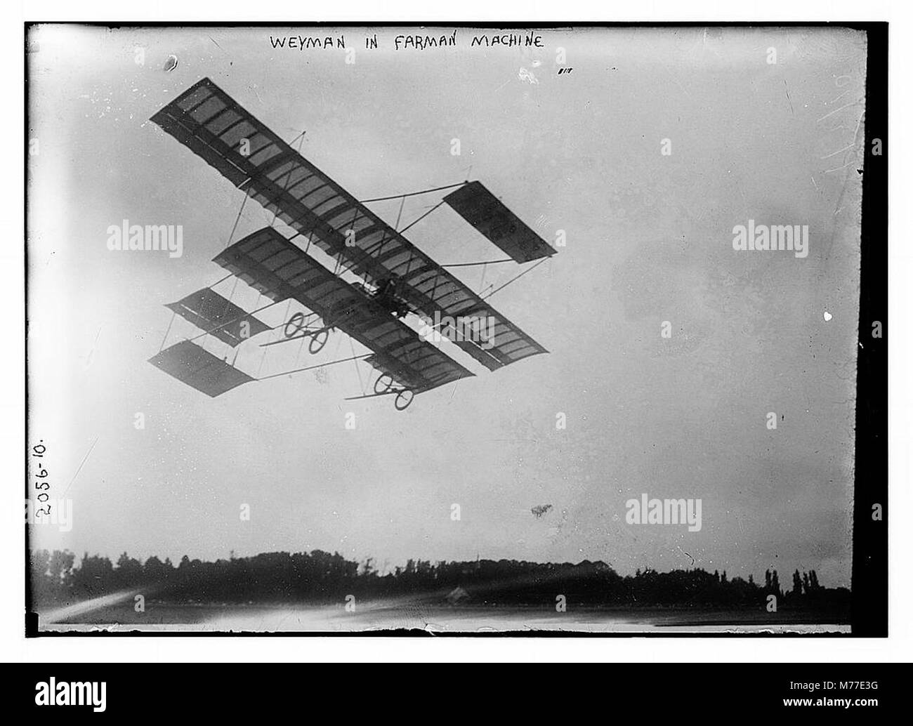 This image captures a pilot named Weuman flying a Farman aircraft ...
