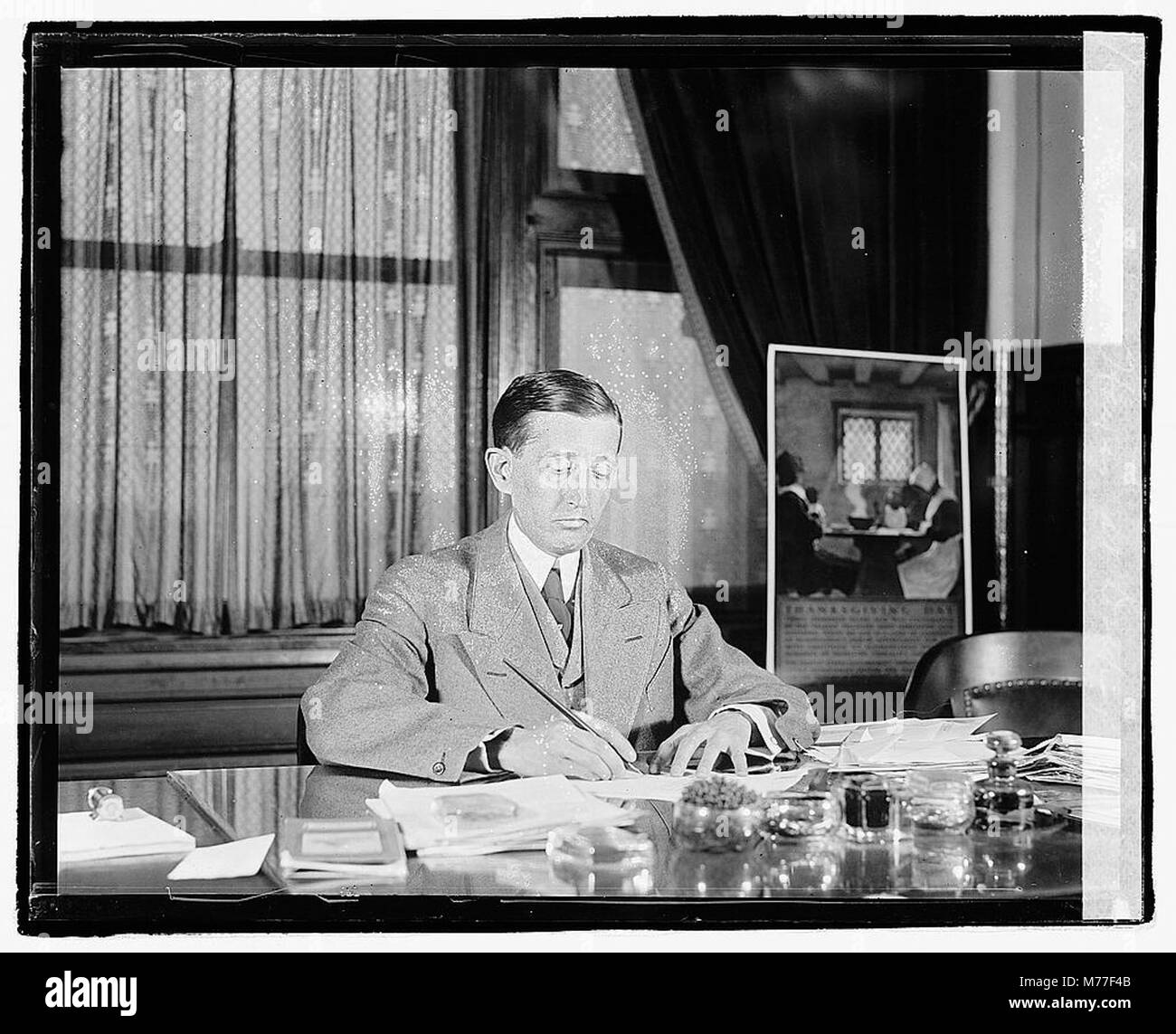 This photograph captures Will Hayes seated at a desk, a key figure ...
