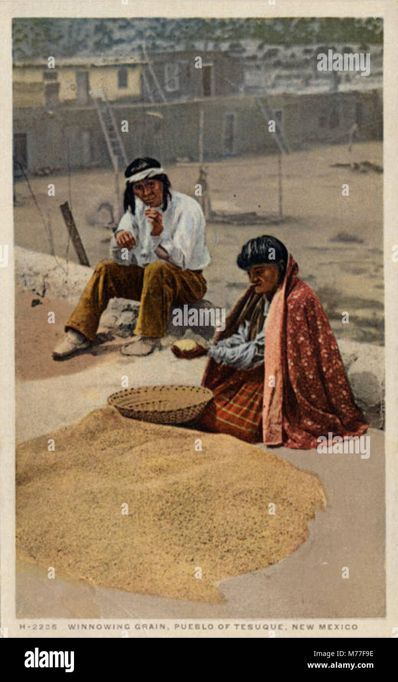 This image captures the process of winnowing grain at the Pueblo of ...