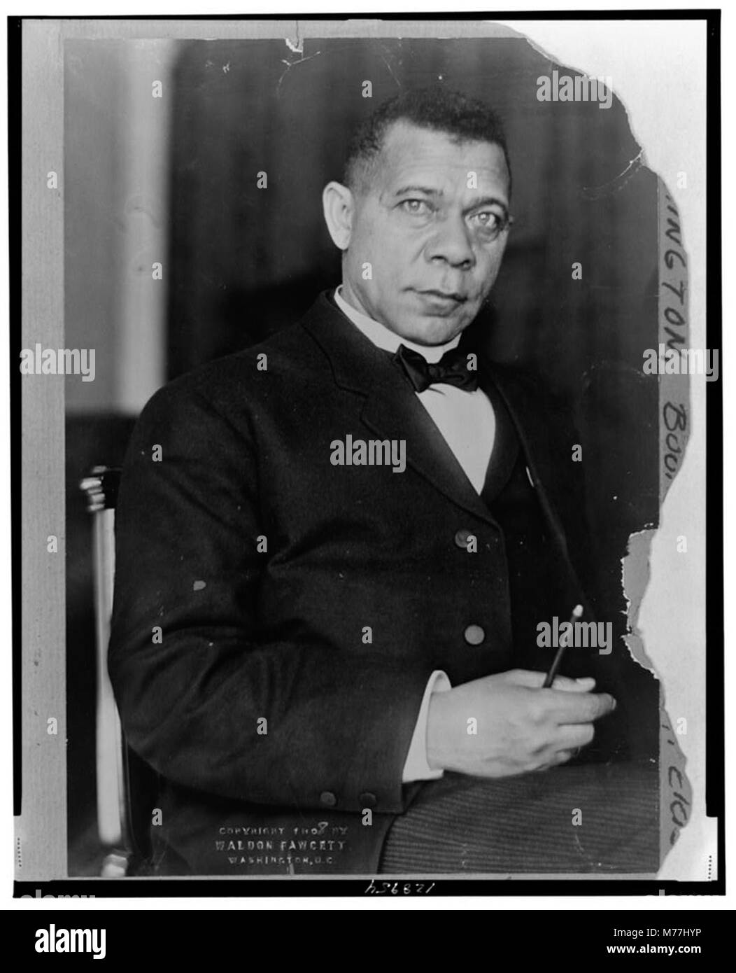 A three-quarter length portrait of Booker T. Washington, the prominent ...