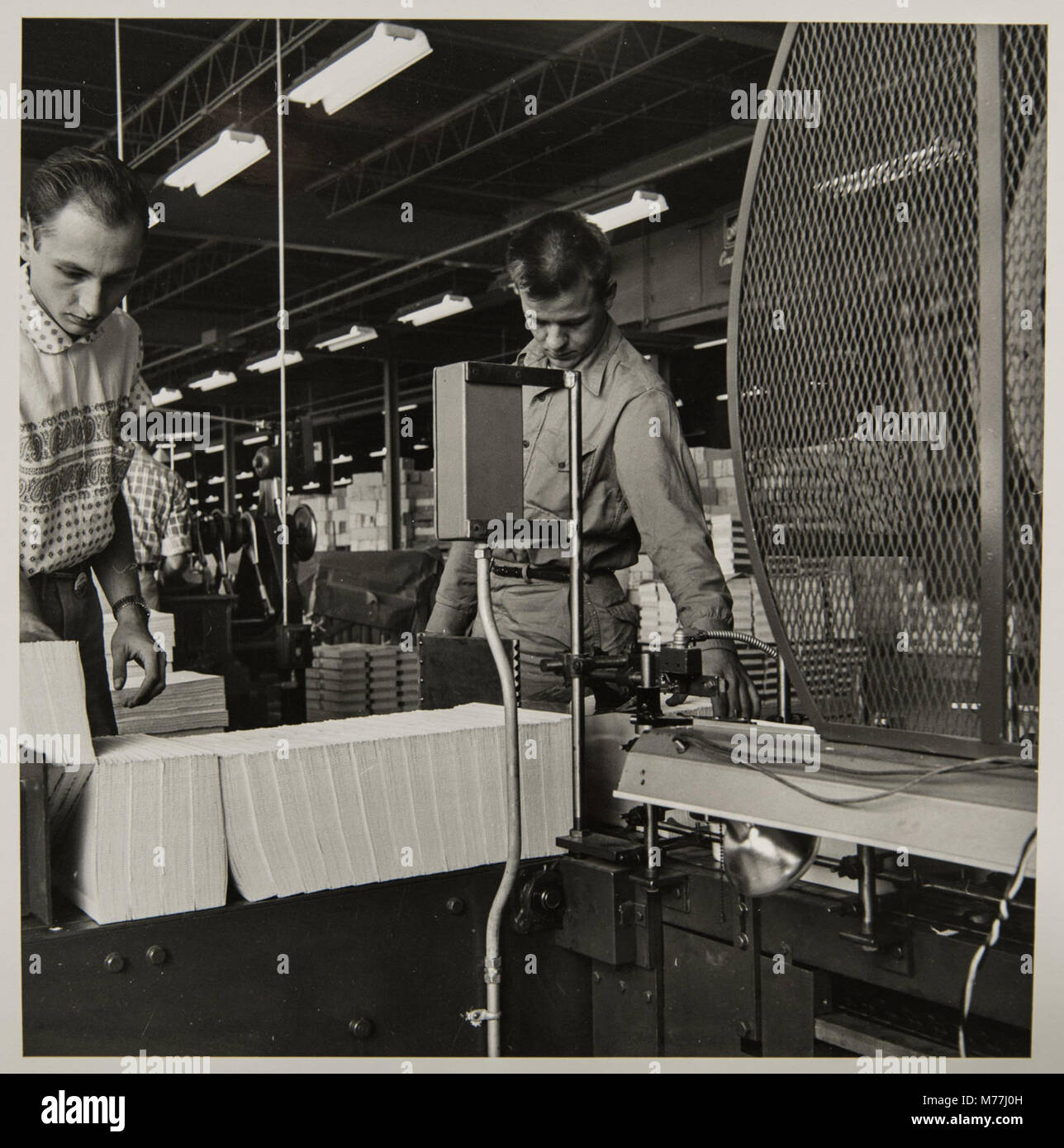 This image focuses on the process of typesetting in book manufacturing ...