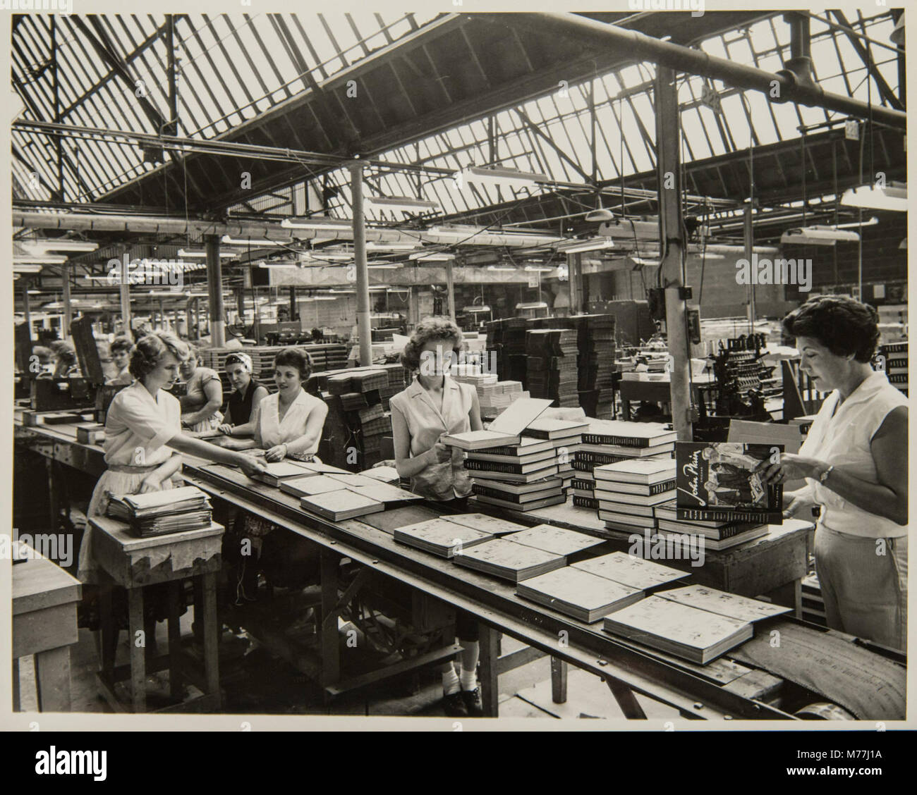 An image illustrating the binding stage of book manufacturing, showing ...