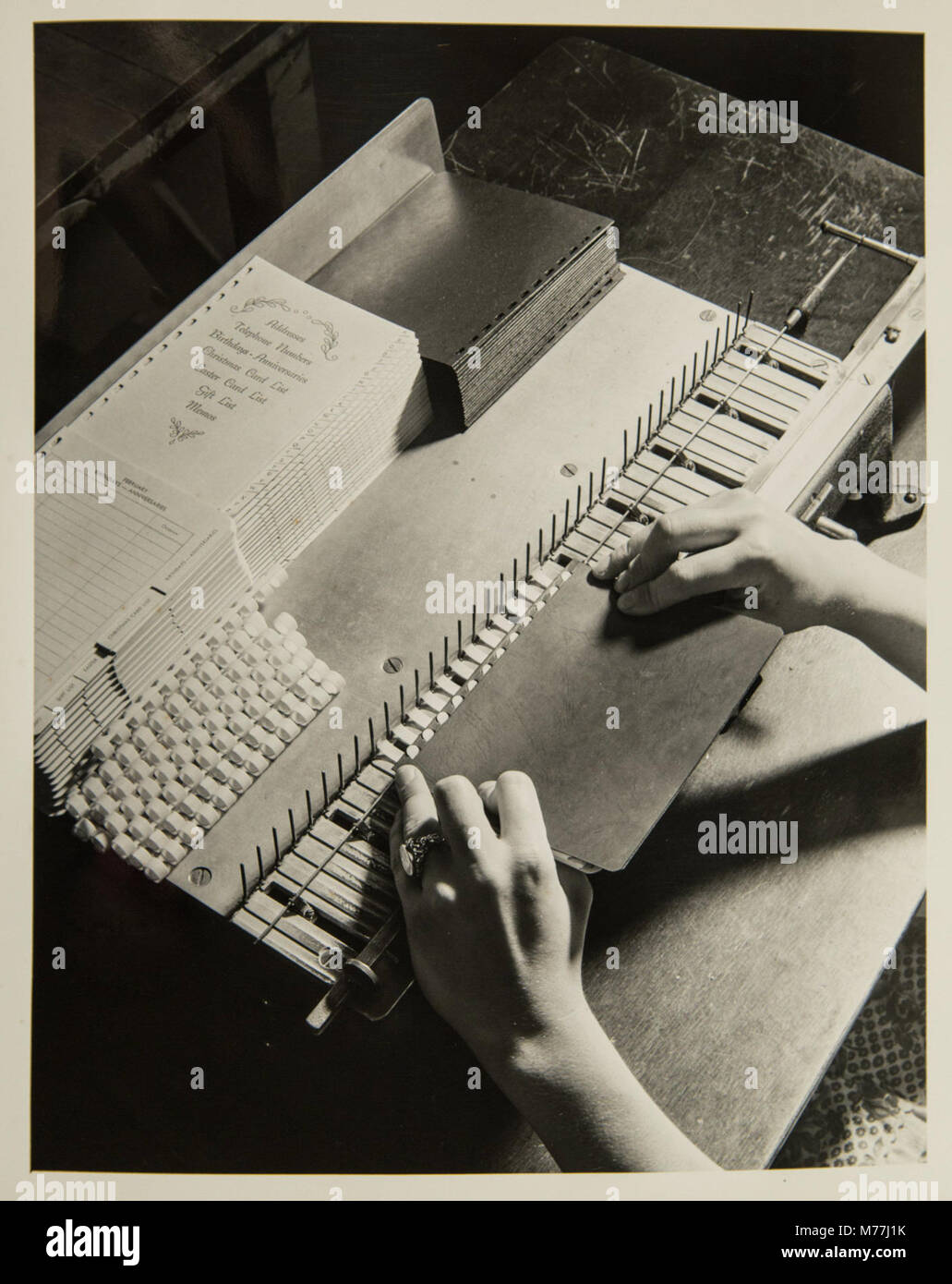 The image shows the process of book manufacturing, specifically ...