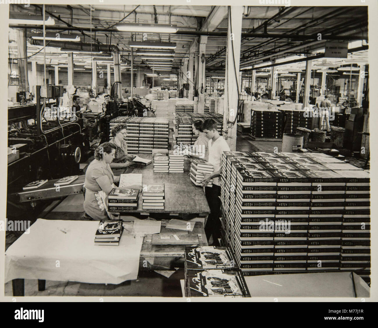 A detailed image showcasing the process of bookbinding in manufacturing ...