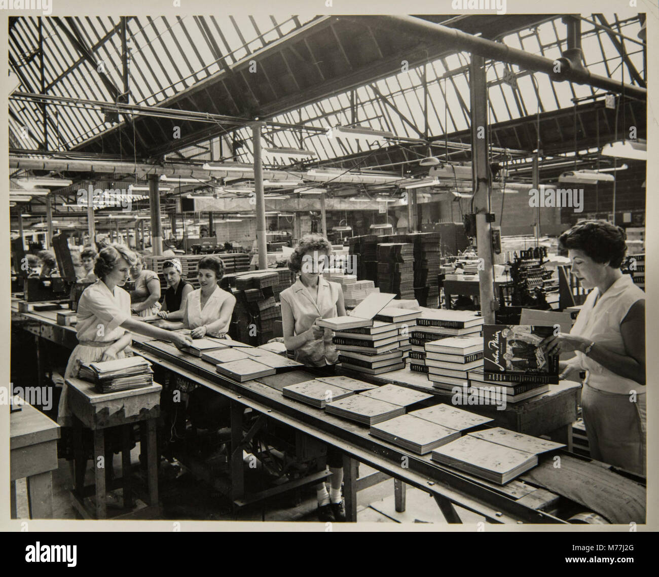 A photograph illustrating the book manufacturing process, focusing on ...