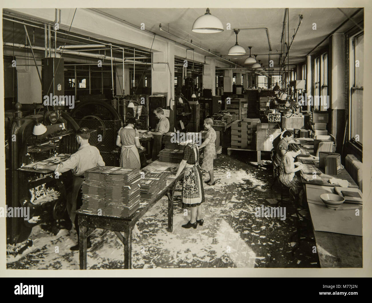 A photograph depicting the book manufacturing process, specifically ...