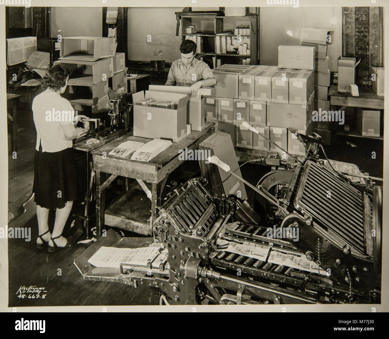A photograph showcasing the bookbinding process in book manufacturing ...