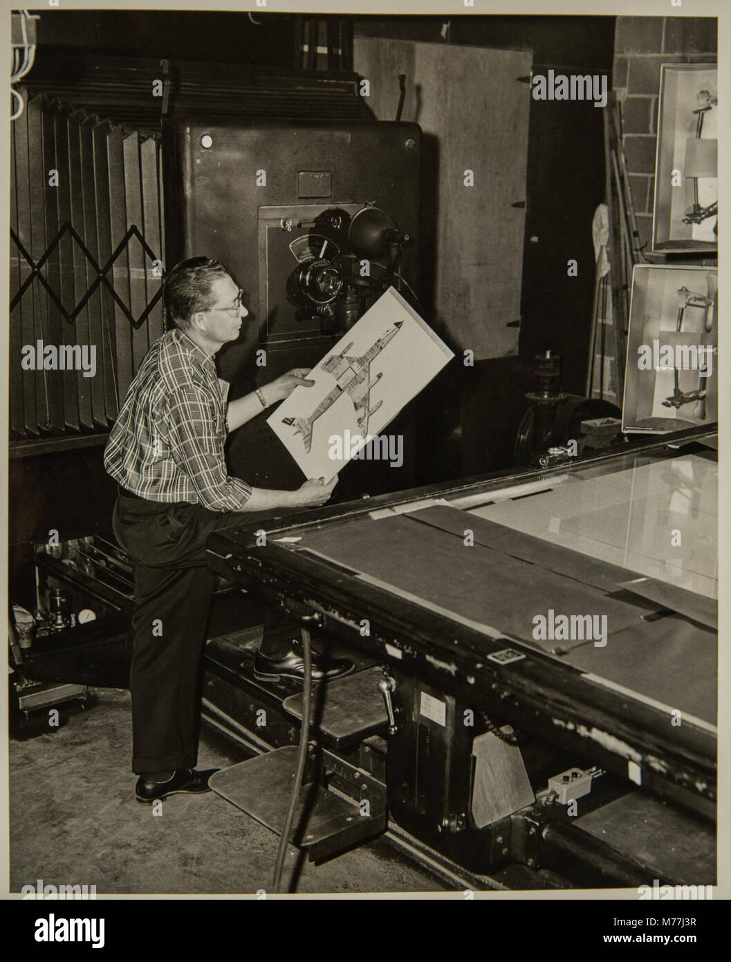 A photo depicting the process of book manufacturing, focusing on the ...