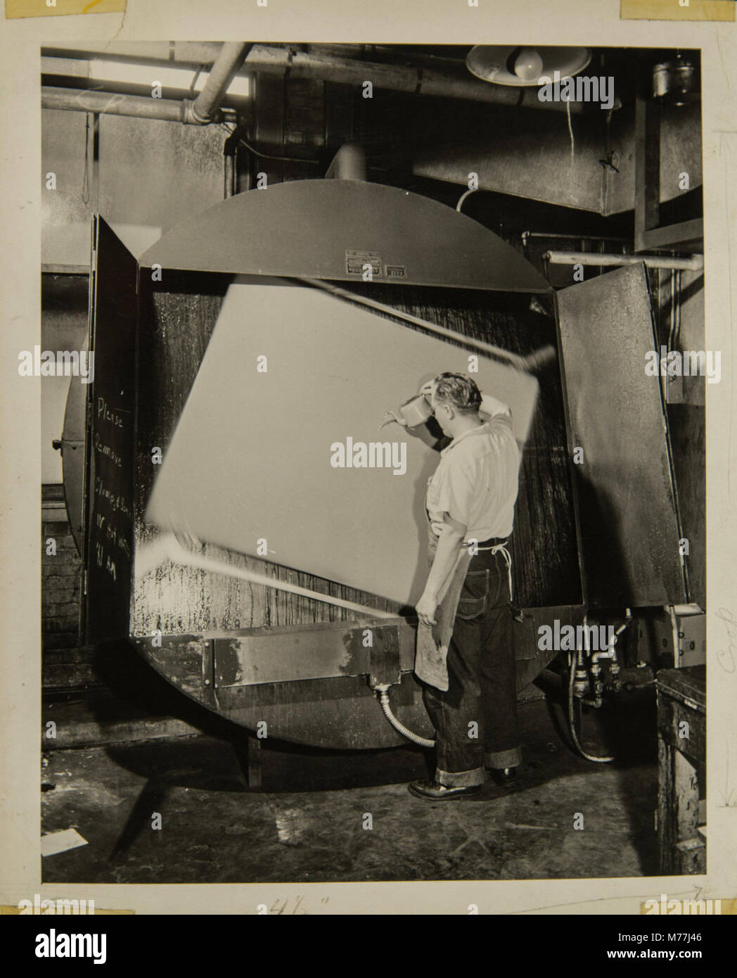 A photograph depicting the process of book manufacturing, focusing on ...