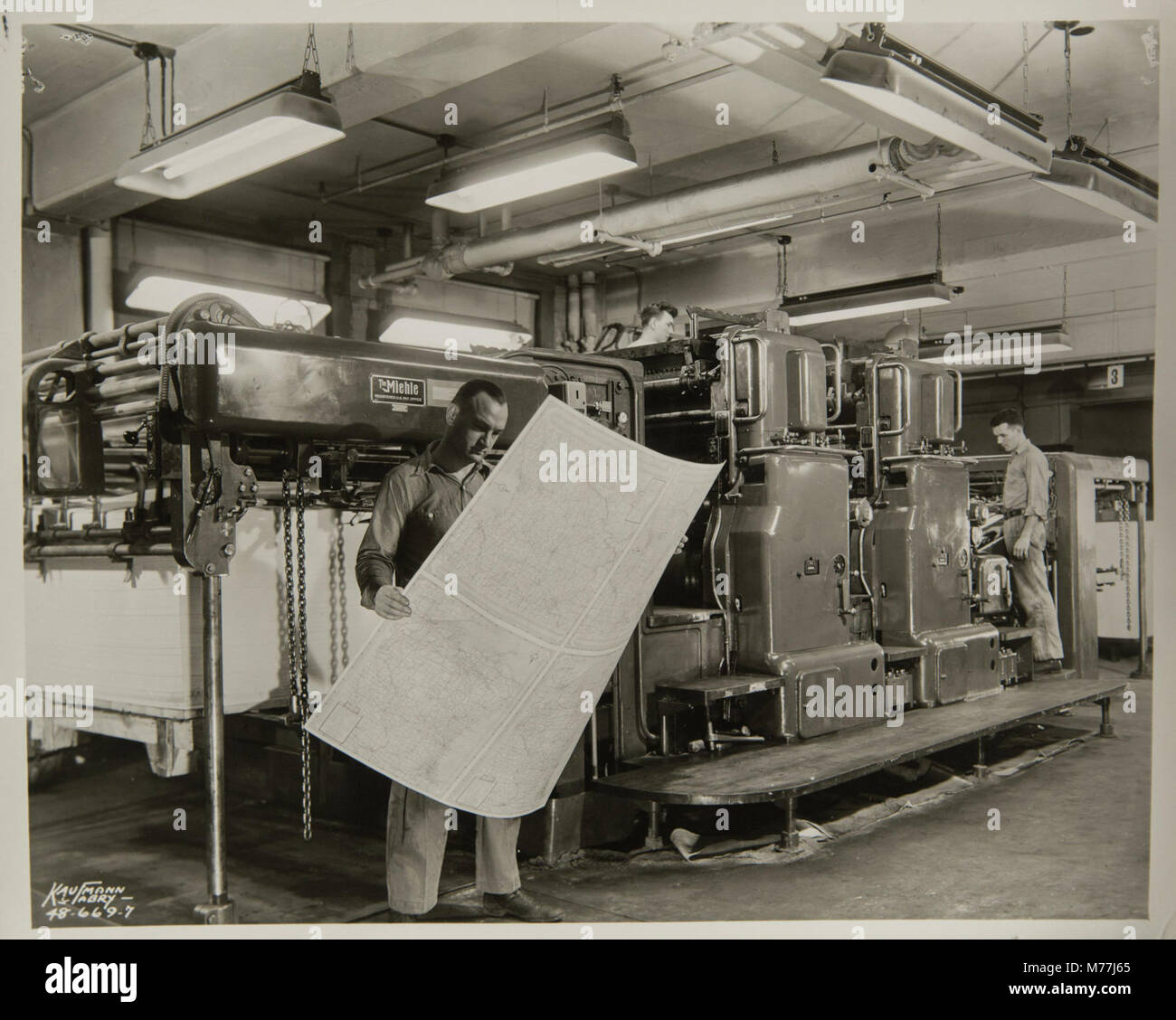 This photograph shows the process of book manufacturing, specifically ...