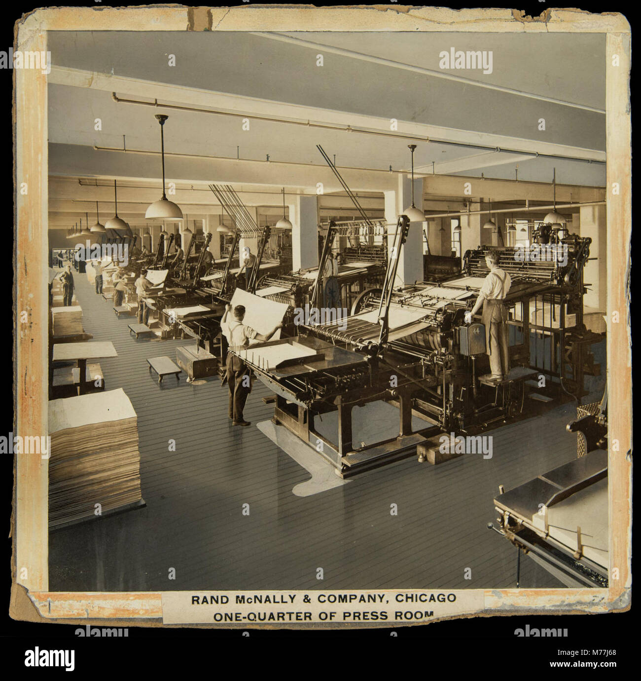 The press room in a book manufacturing facility is shown, illustrating ...