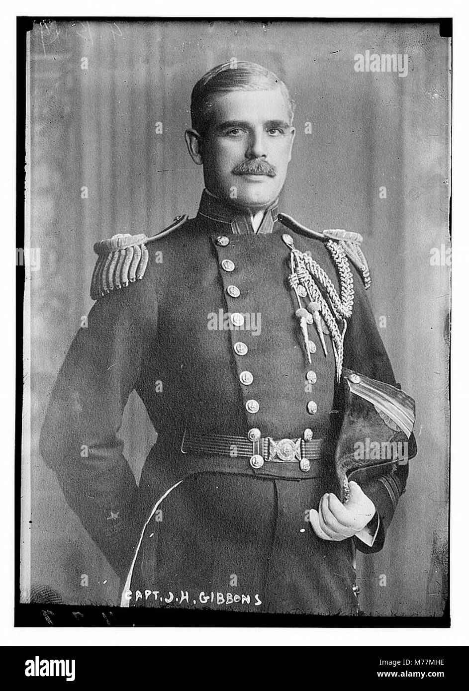 A portrait of Captain J.H. Gibbons, captured in a professional military ...