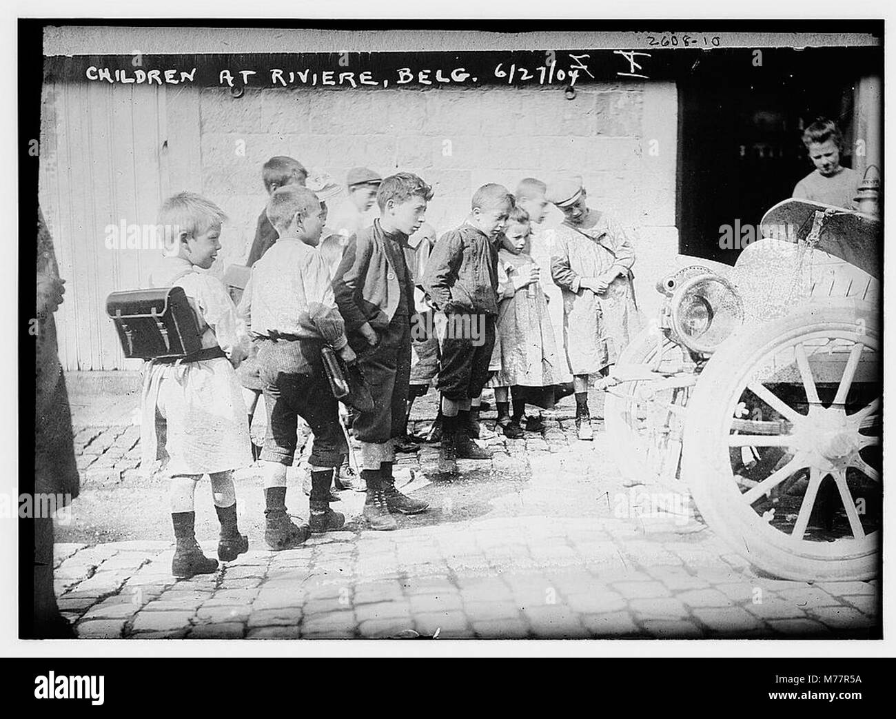 A historical photograph of children at the Riviere, Belgium, showcasing ...
