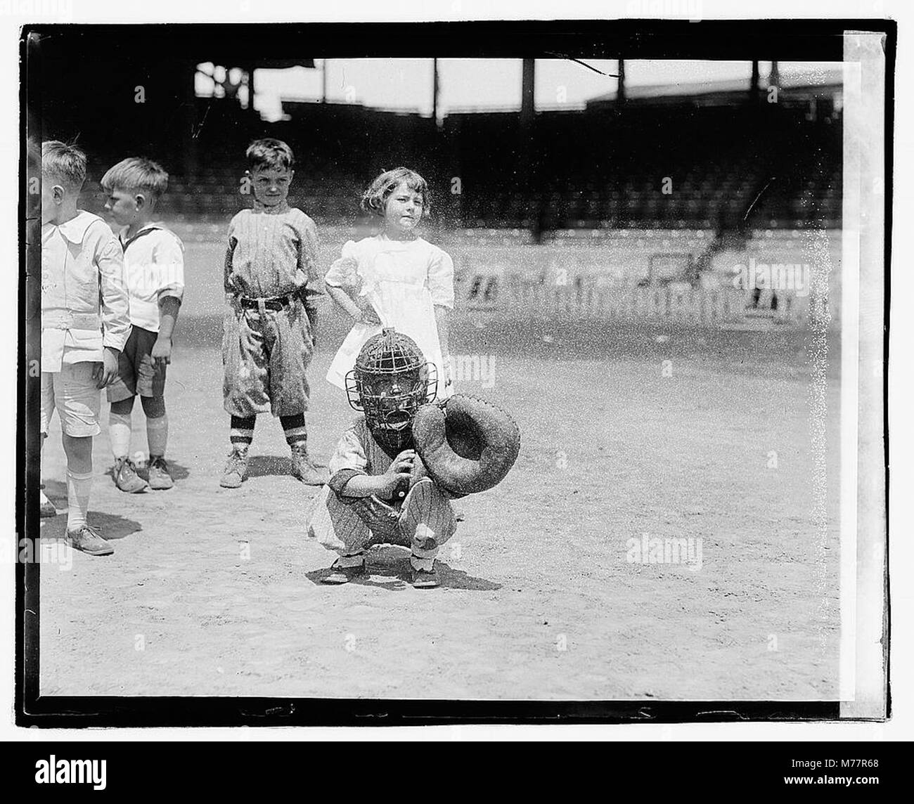 A photograph of children playing baseball, capturing a moment of ...