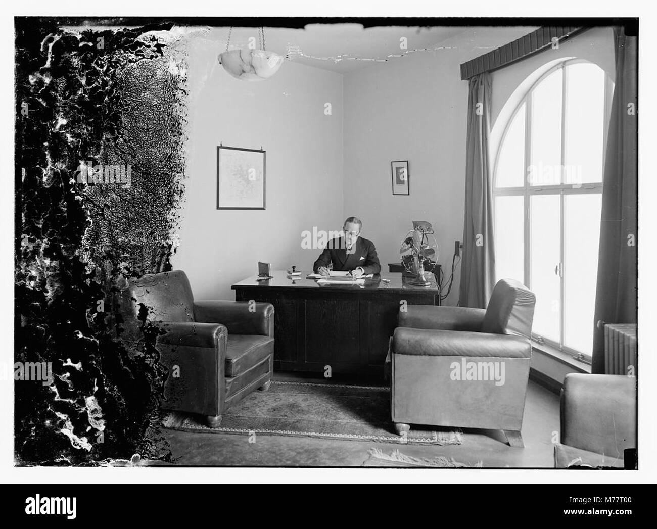 A photograph of an individual named Clark sitting at a desk ...