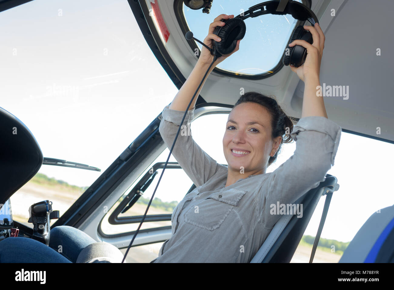 pretty pilot woman on helicopter background Stock Photo - Alamy