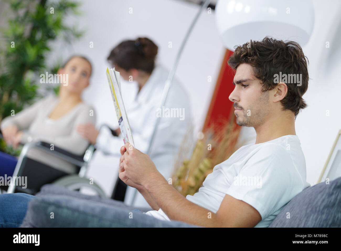 Young Person Reading Magazine While Waiting Room High Resolution Stock ...