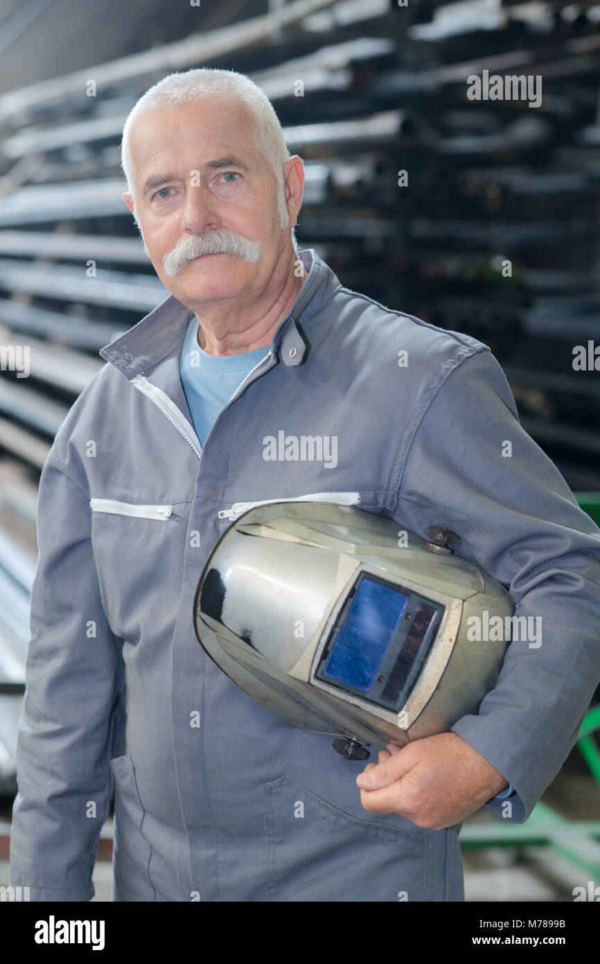 portrait of older male steel worker welding with protective mask Stock ...