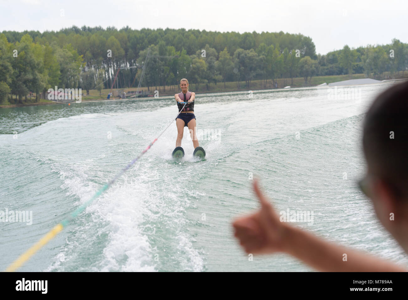 woman riding on wave of motorboat in a summer lake Stock Photo - Alamy