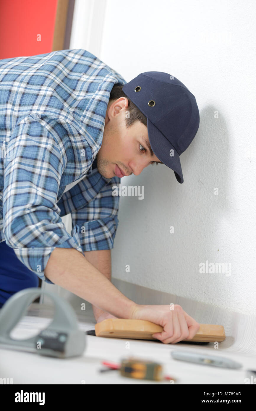 a carpenter is renovating floor Stock Photo - Alamy