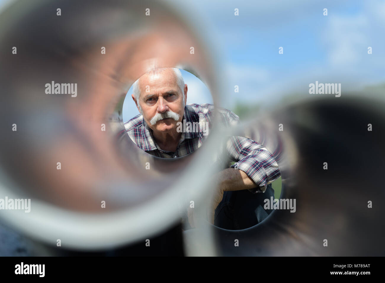 Old man looking through telescope hi-res stock photography and images ...
