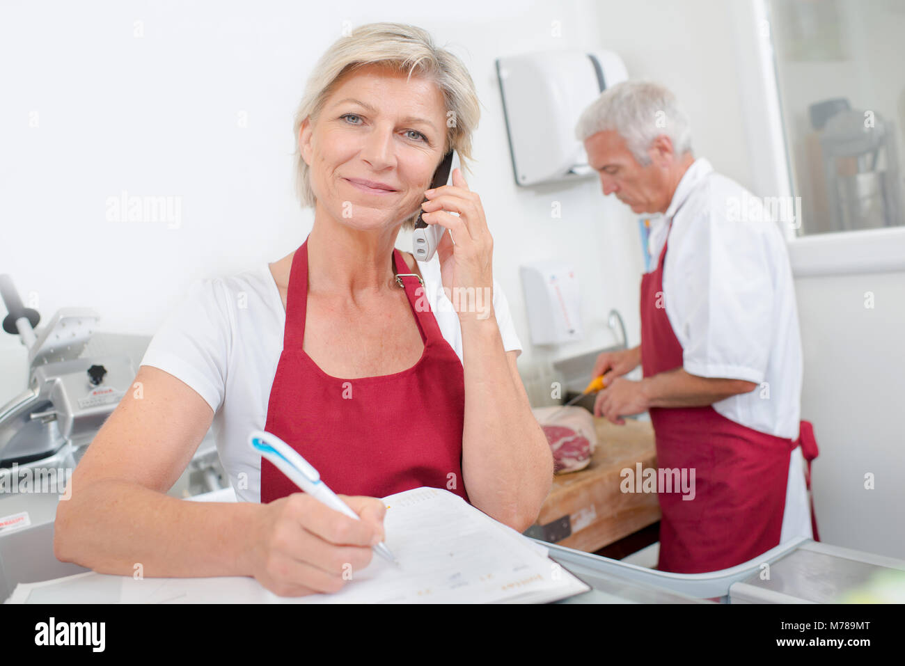 Butcher owner telephone Stock Photo - Alamy