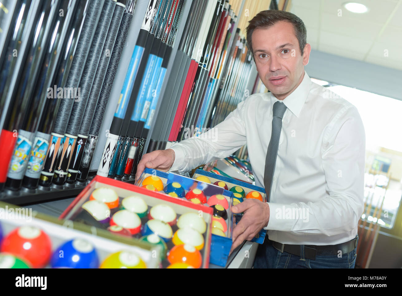 Man with boxes of pool balls Stock Photo - Alamy
