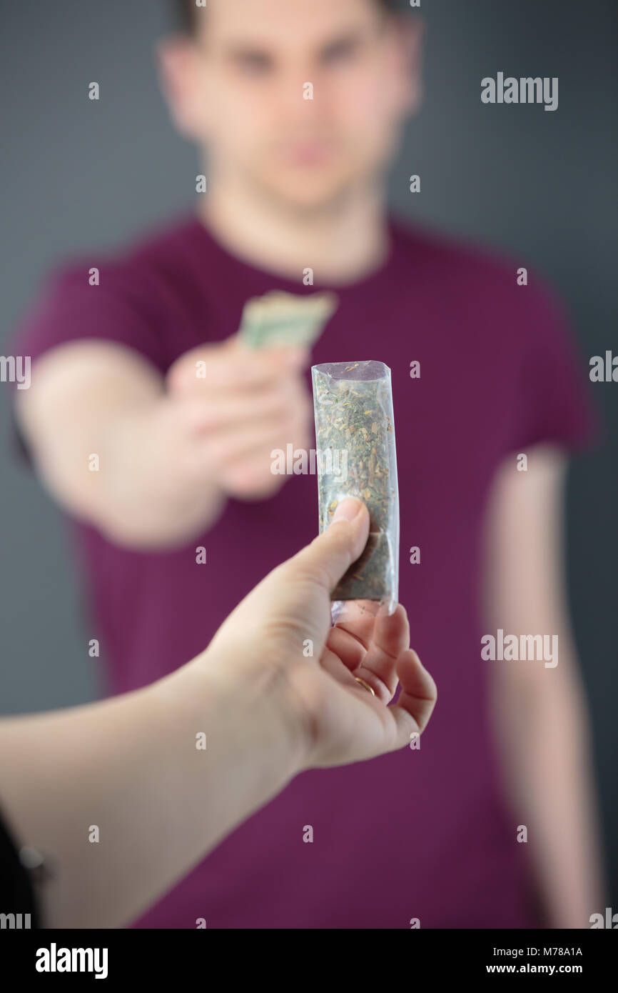 drug dealer giving cannabis to addict paying him back Stock Photo - Alamy