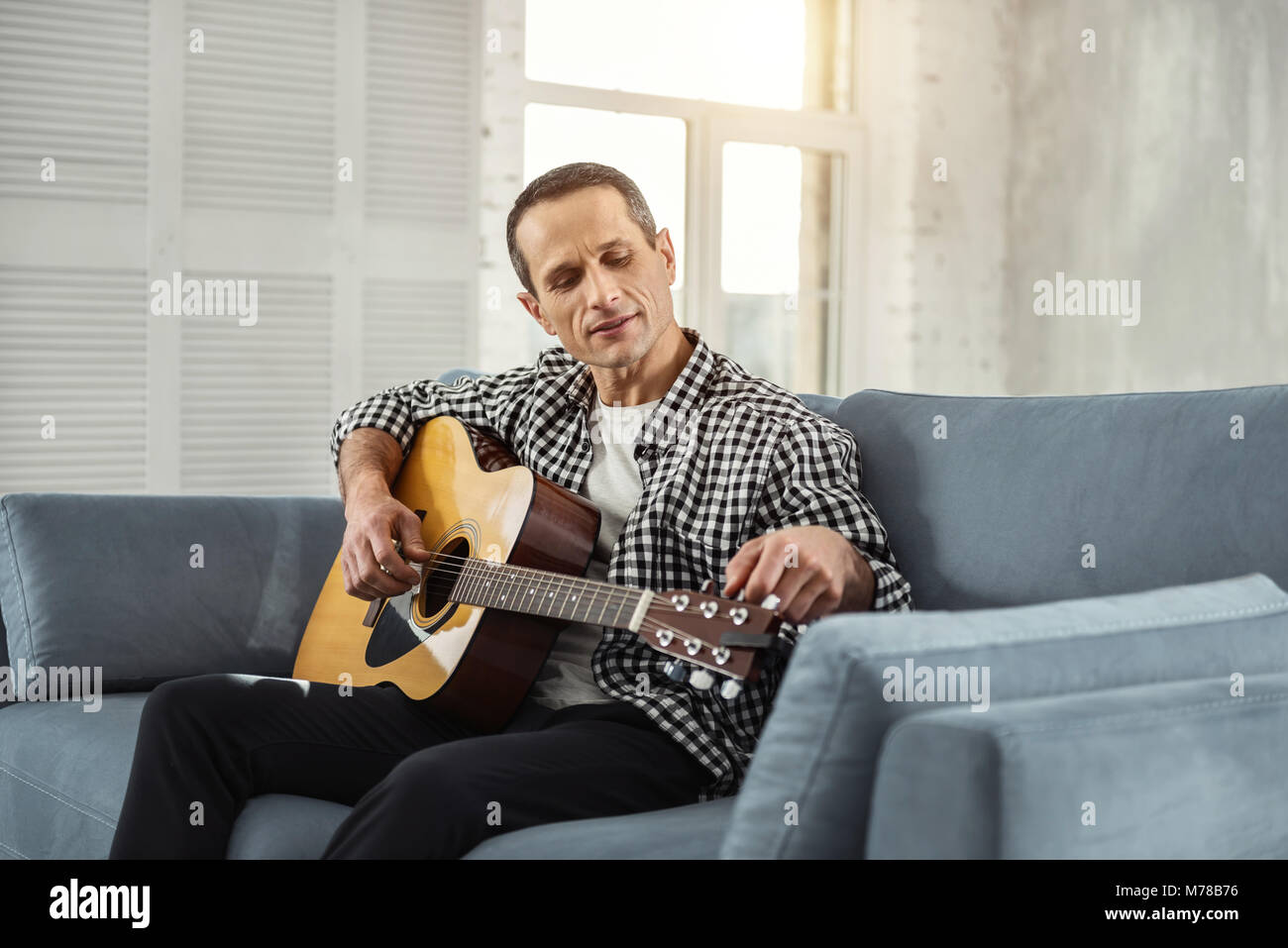 Content man relaxing and playing the guitar Stock Photo - Alamy