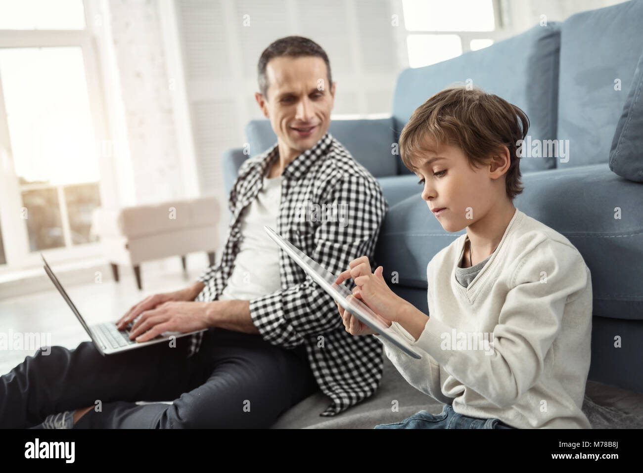 Serious young boy typing on his laptop Stock Photo - Alamy