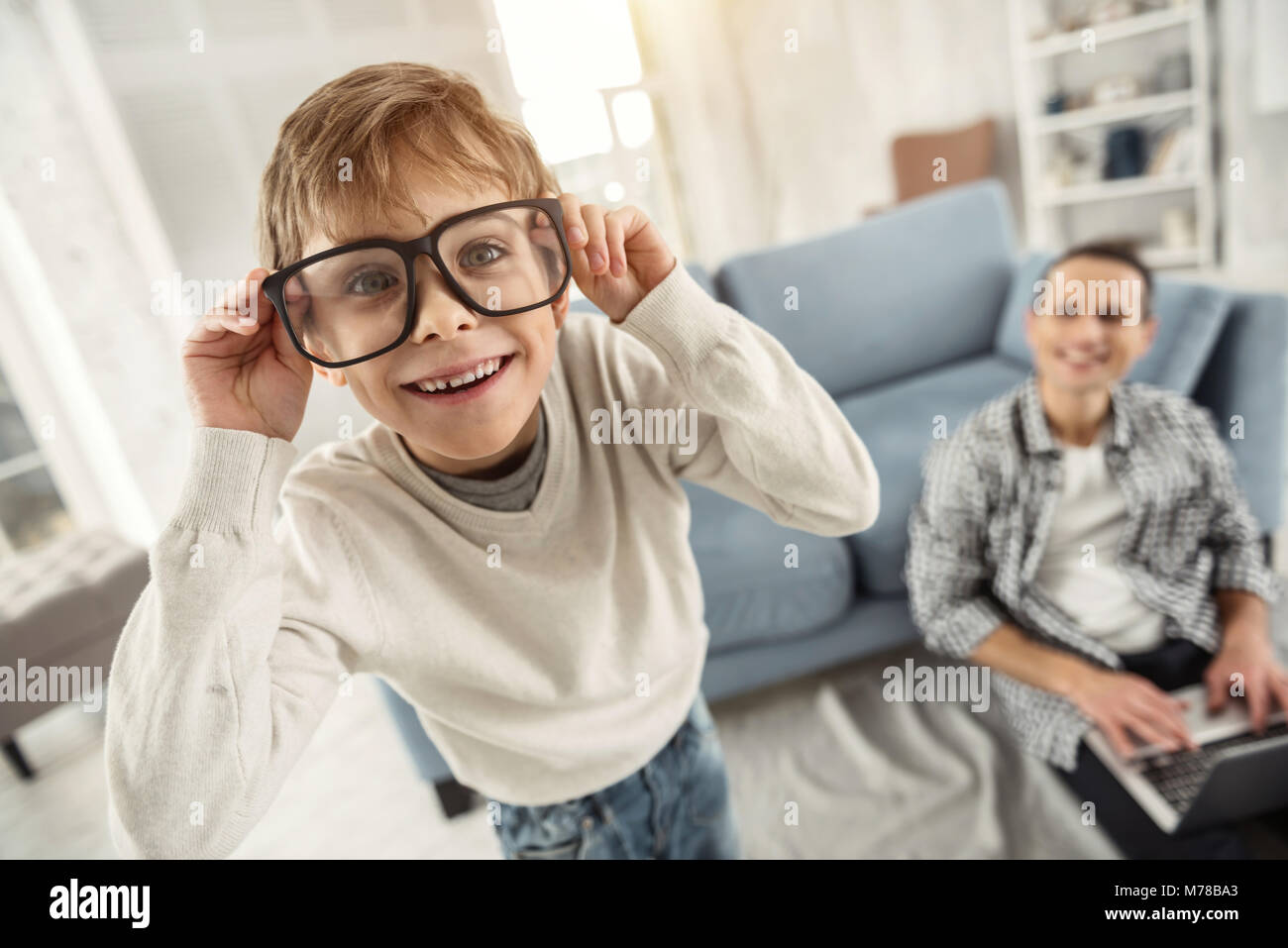 Delighted boy wearing big glasses Stock Photo - Alamy