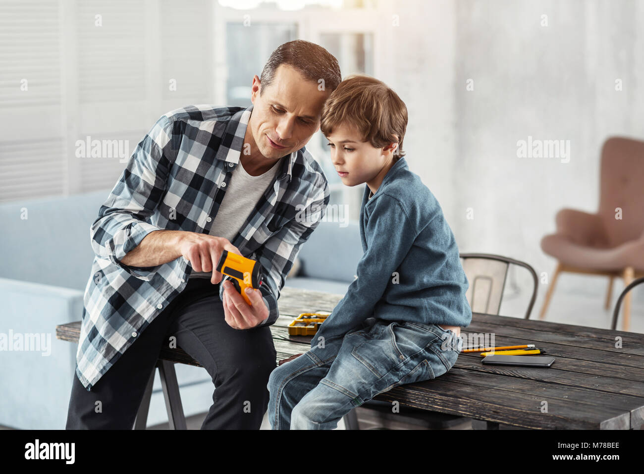 Smiling daddy showing his instruments to his son Stock Photo - Alamy