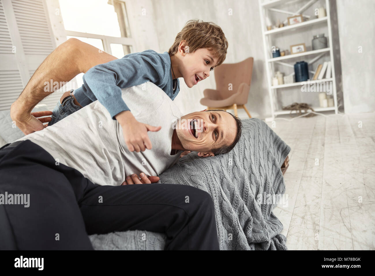 Joyful father and son having fun Stock Photo - Alamy