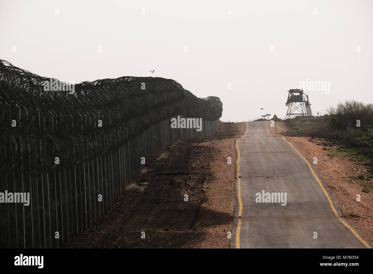 An Israeli military watchtower placed next to the border fence ...