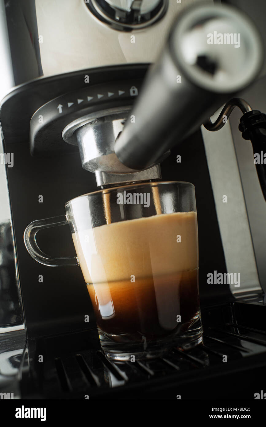 Espresso pouring from coffee machine. Professional coffee brewing Stock ...