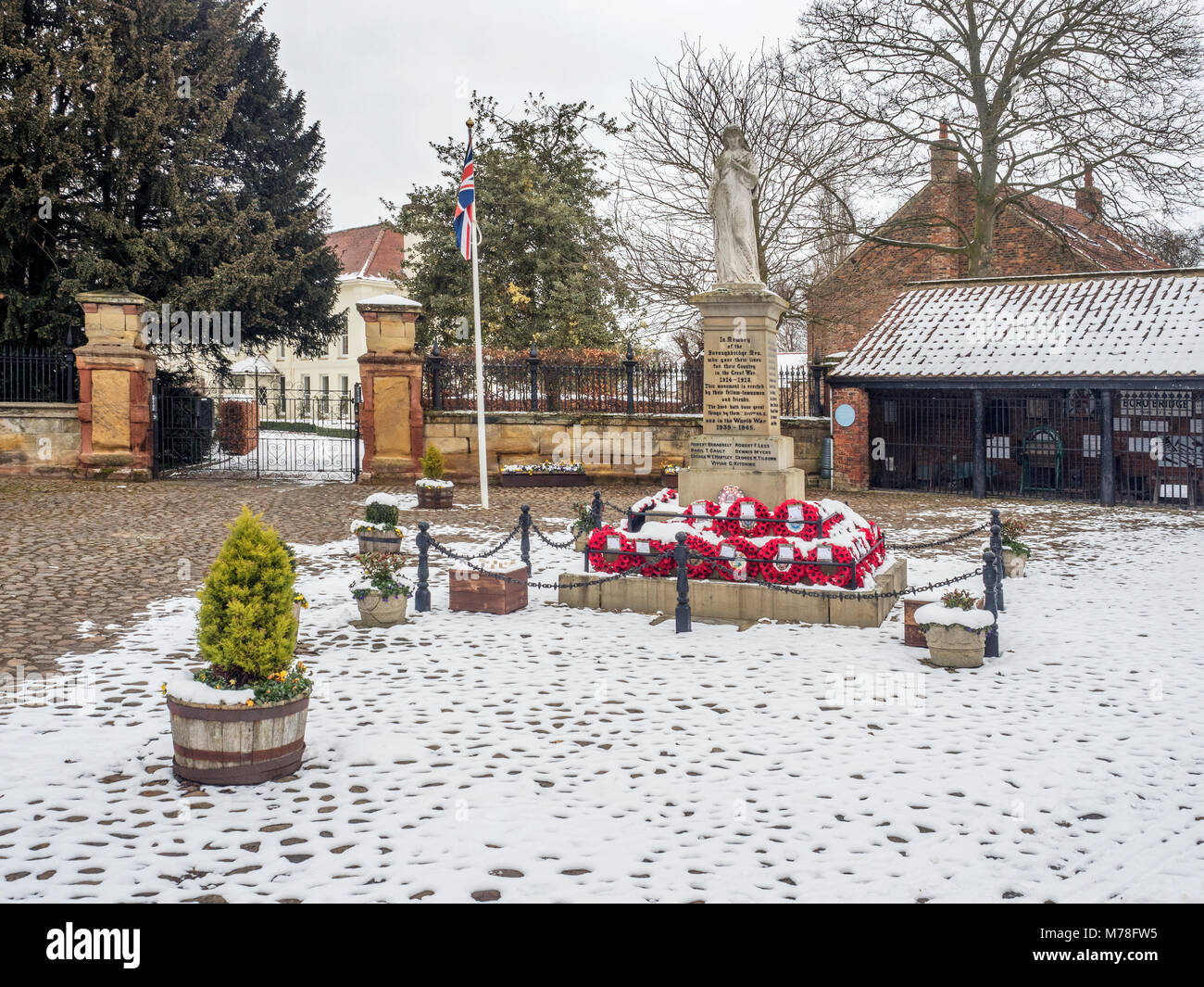 Snow on the cobbles around the war memorial in Hall Square at ...