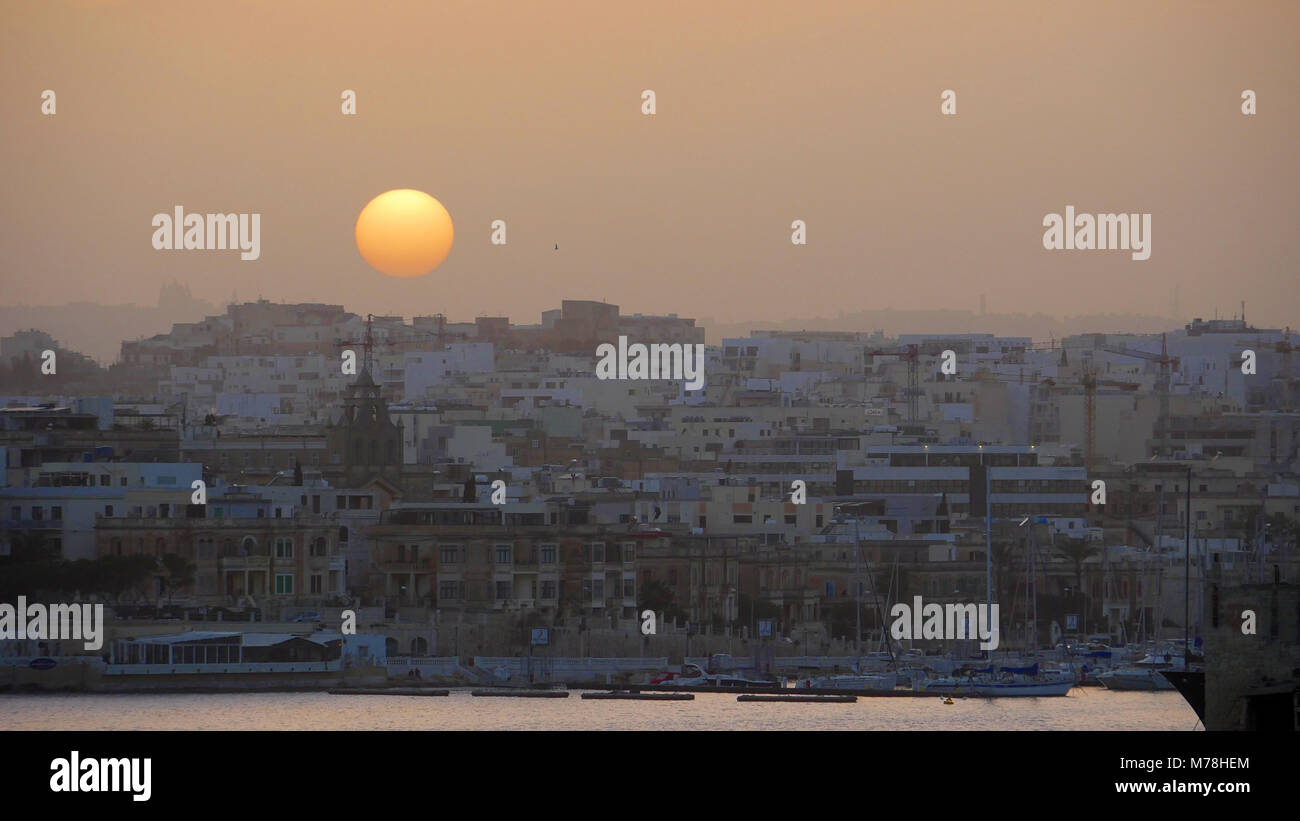 The Sun setting over Valletta in Malta Stock Photo - Alamy