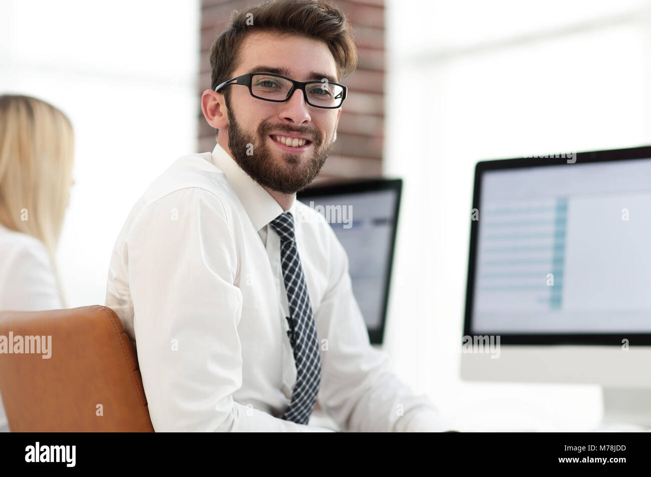 experienced programmer sitting in front of the monitor. office work ...