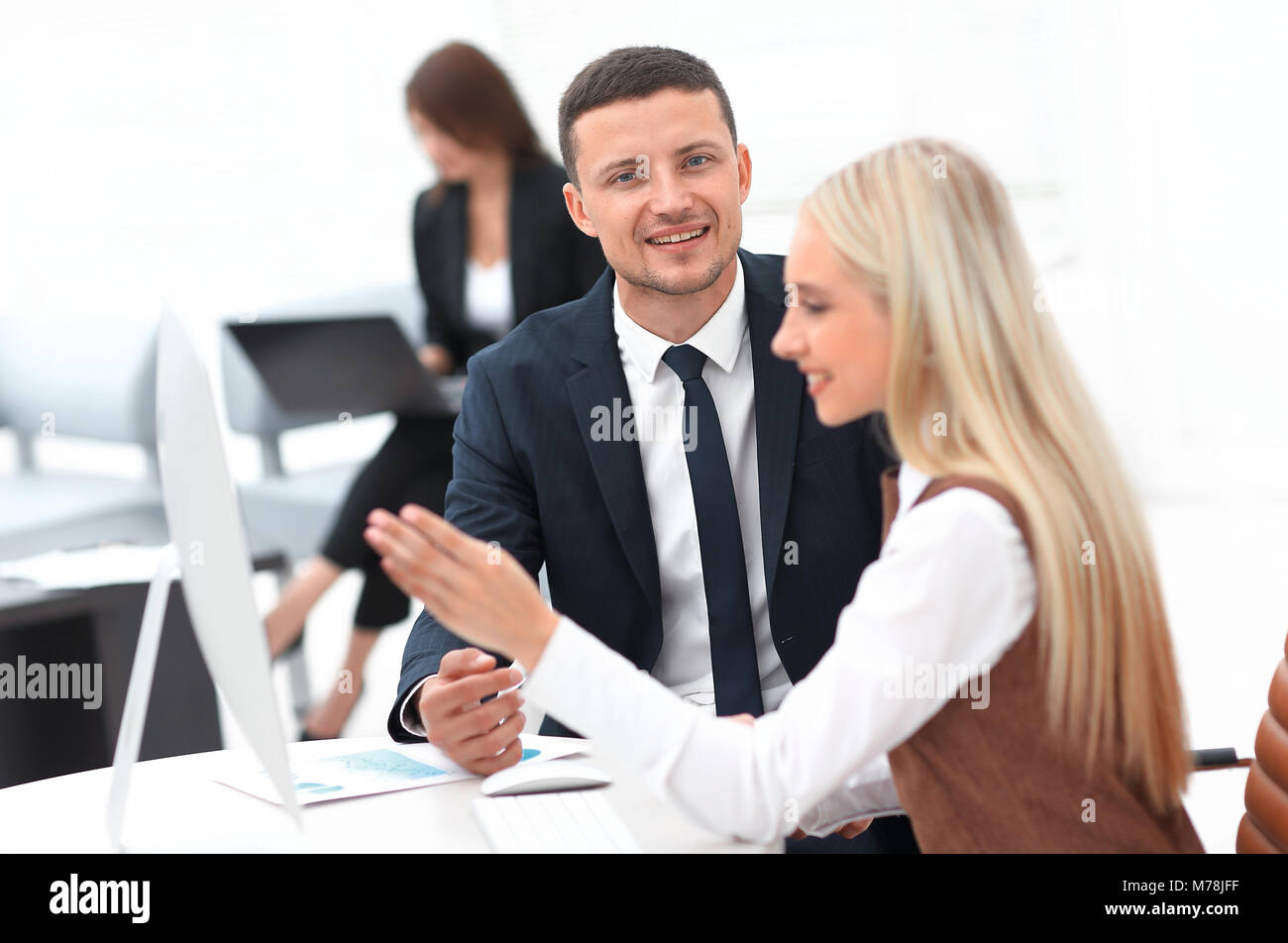 Manager talking with a colleague at the workplace . photo with copy ...